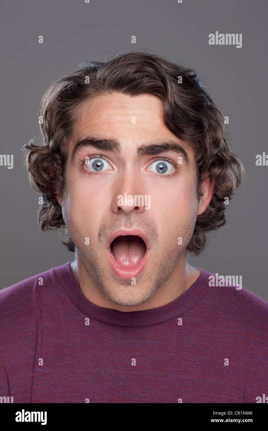 Studio shot of surprised young man Stock Photo - Alamy