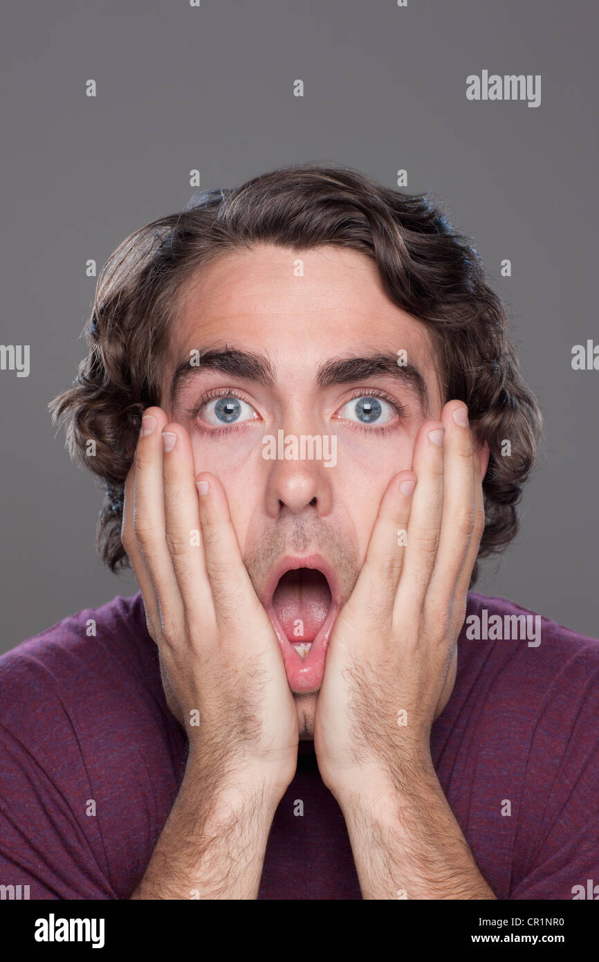 Studio shot of shocked young man Stock Photo - Alamy