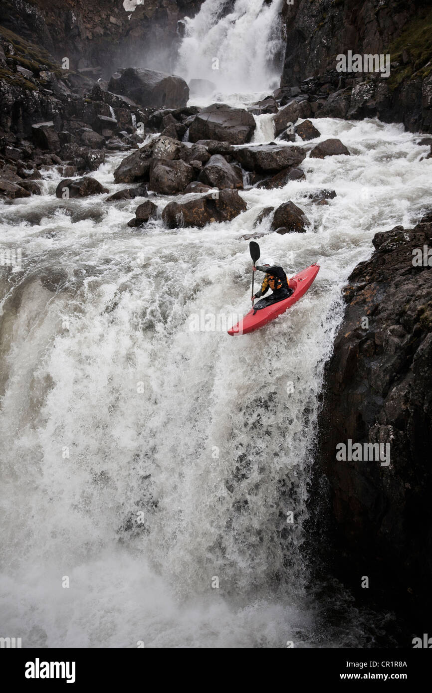 Man canoeing over rocky waterfall Stock Photo - Alamy