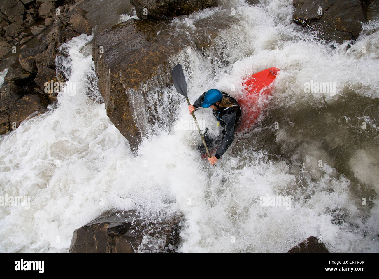 Man canoeing over rocky waterfall Stock Photo - Alamy
