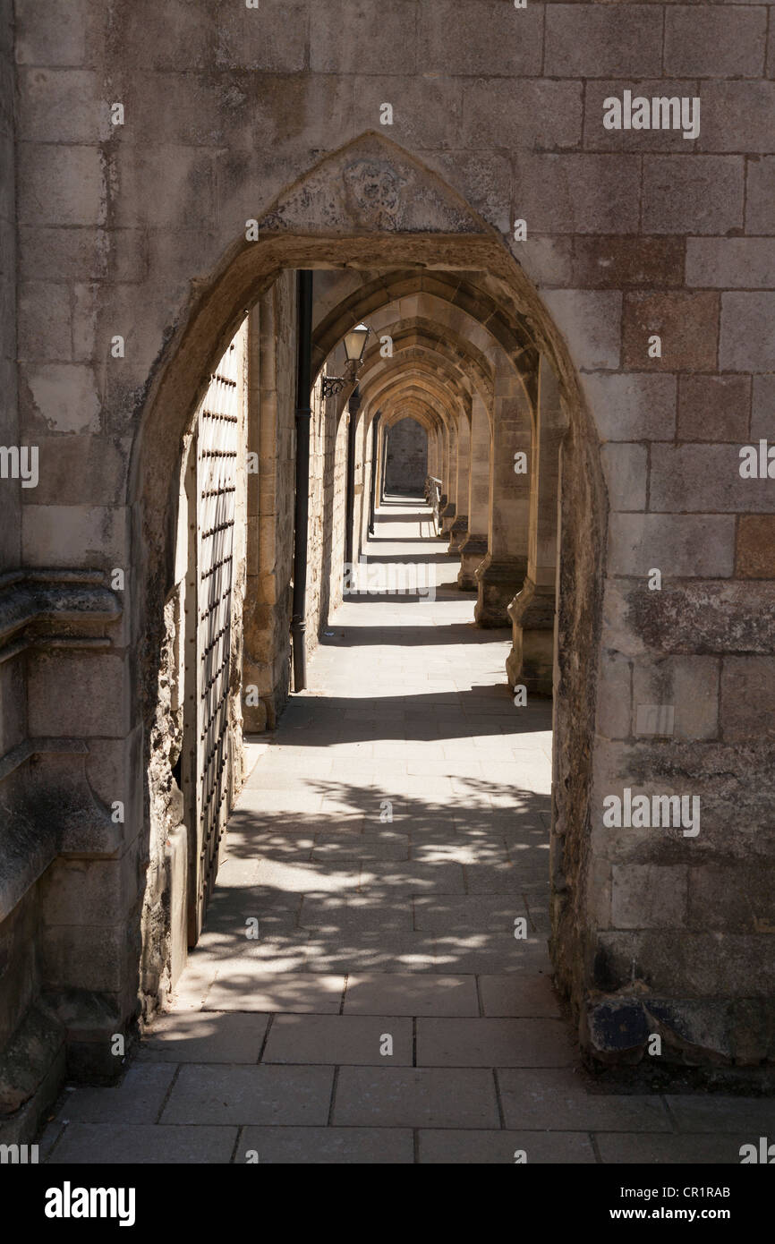 Arches alongside Winchester Cathedral with sunlight and shadow pattern ...