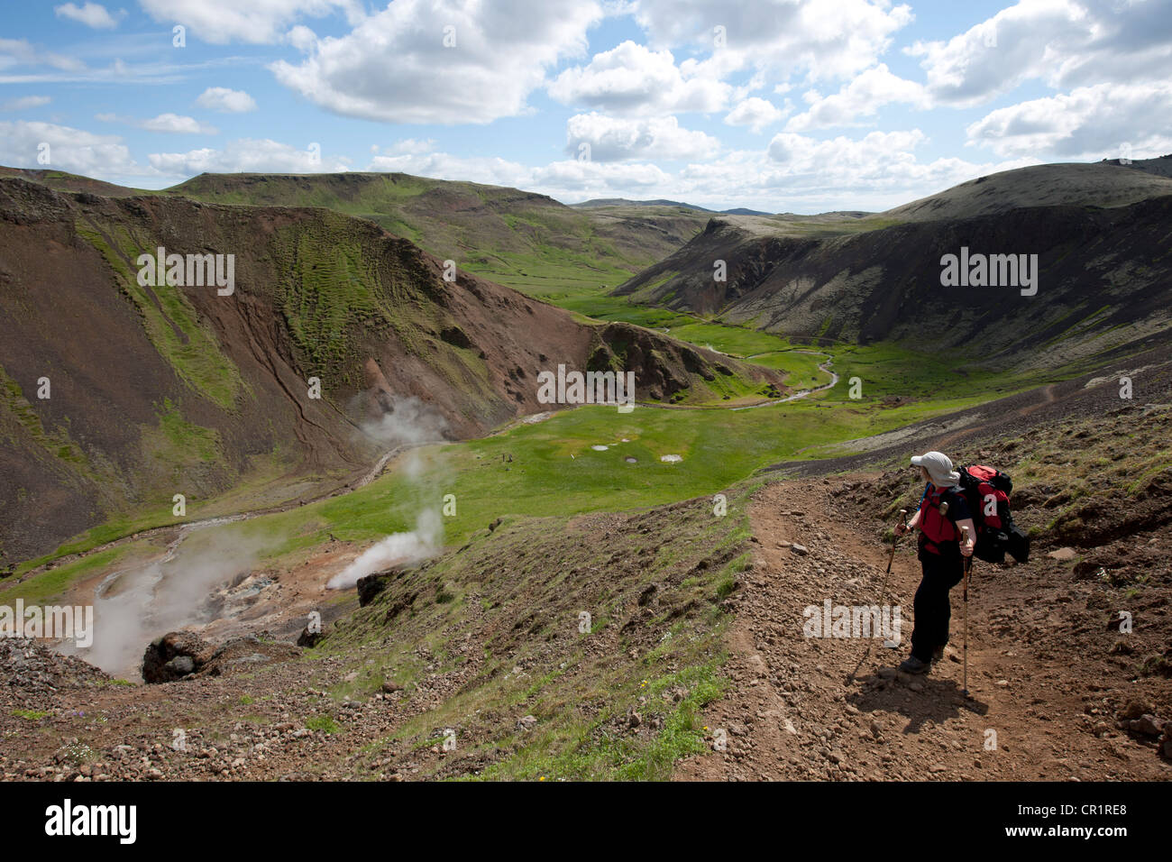 Female hiker above the hot Reykjadalsá river in the Hengill geothermal ...