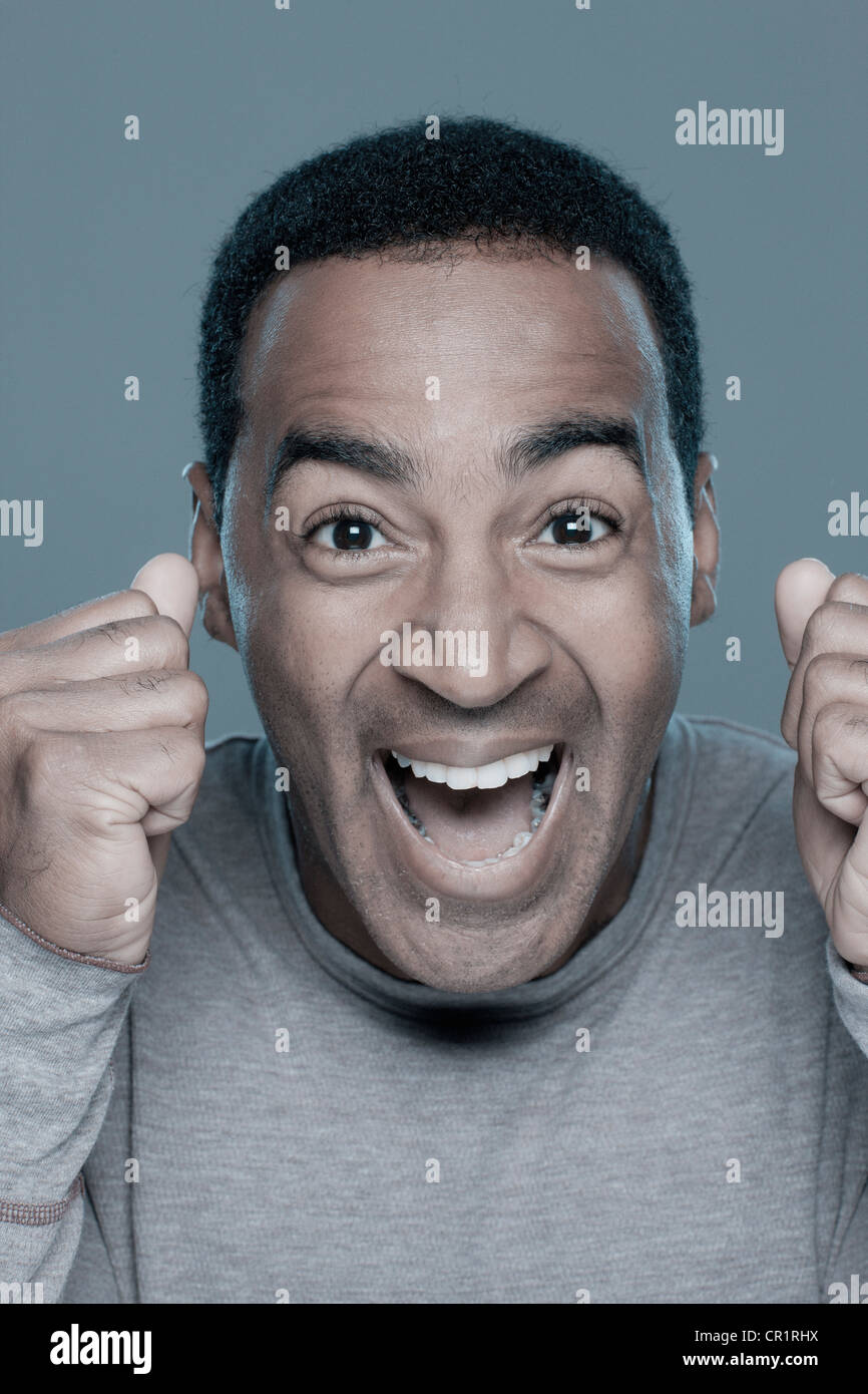 Studio shot of excited man Stock Photo - Alamy