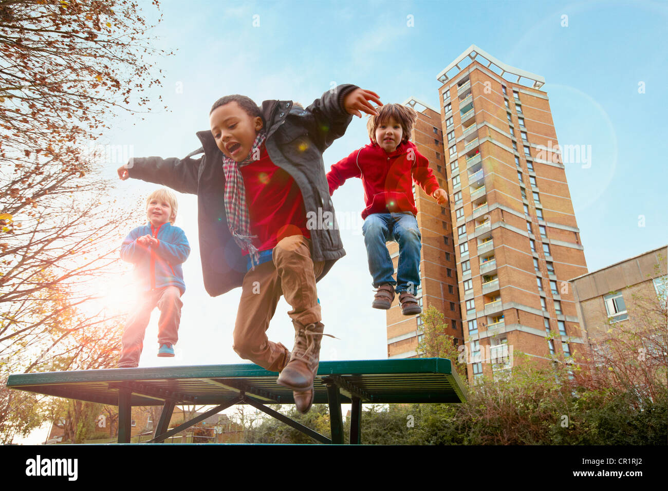 Children jumping for joy in park Stock Photo - Alamy