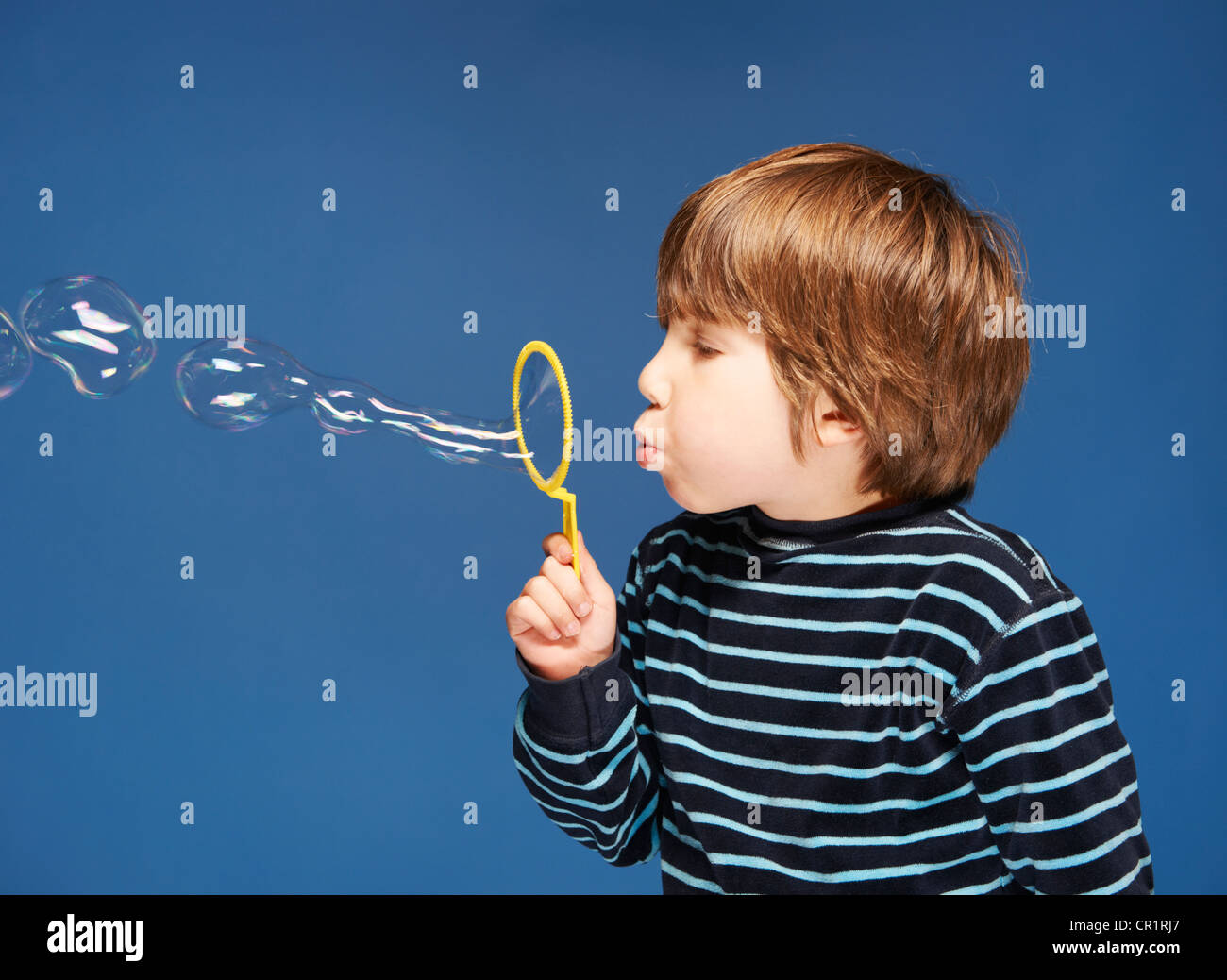 Children blow side hi-res stock photography and images - Alamy