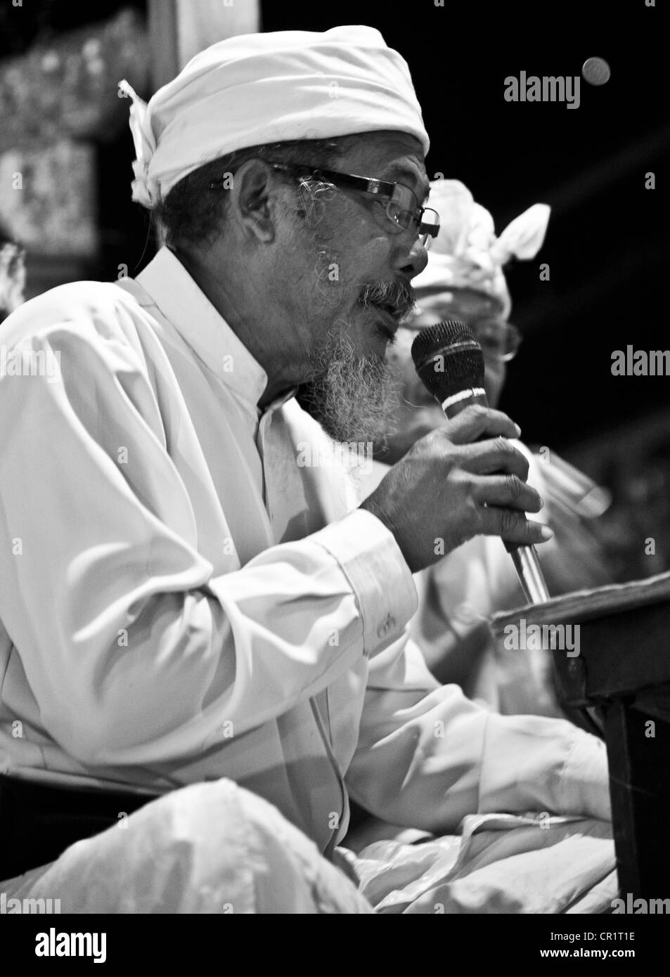 Priest with microphone Stock Photo - Alamy