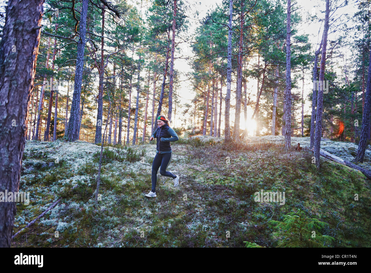 Woman running in forest Stock Photo - Alamy