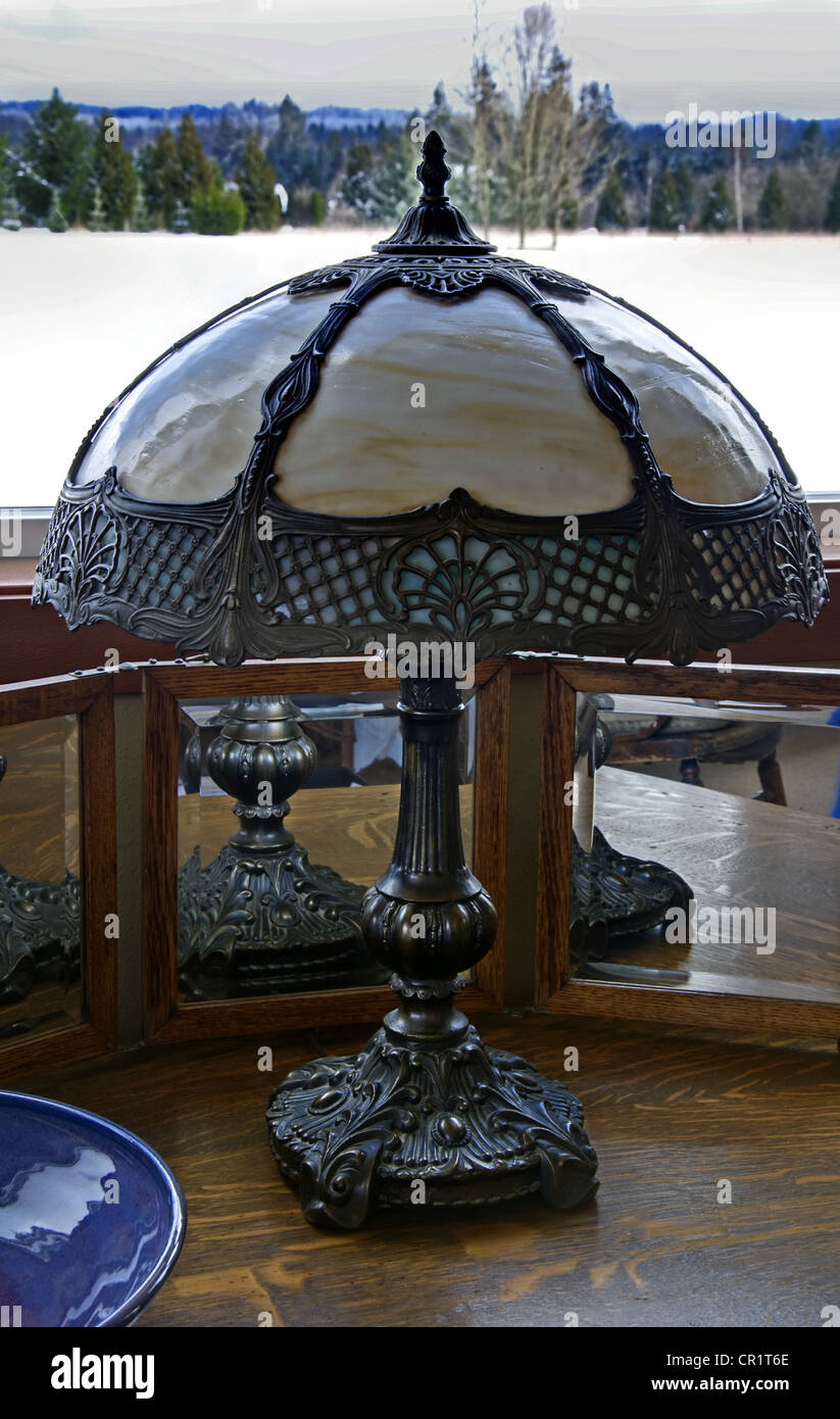 antique decorative metal lamp is the focal point in this still life ...