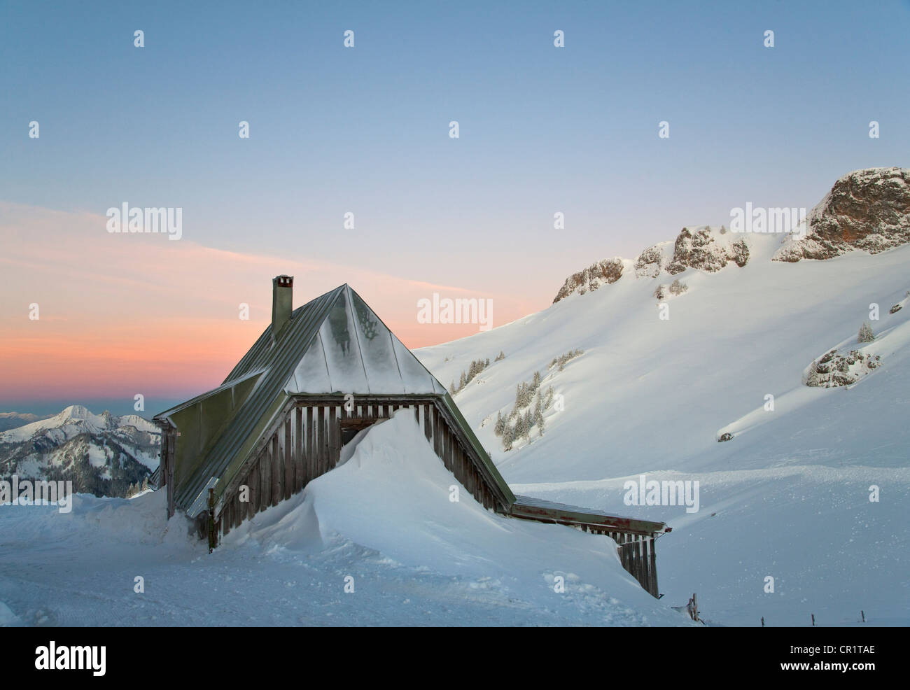 Snow piled up by house on hillside Stock Photo - Alamy