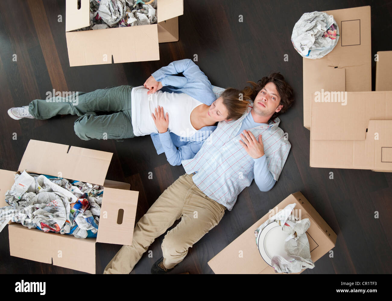 Couple laying together on floor Stock Photo - Alamy