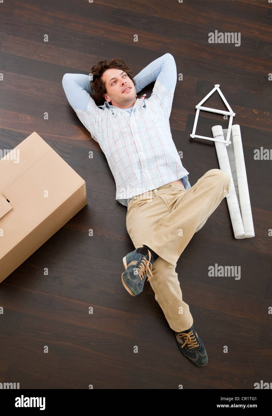 Man laying on floor with boxes Stock Photo - Alamy