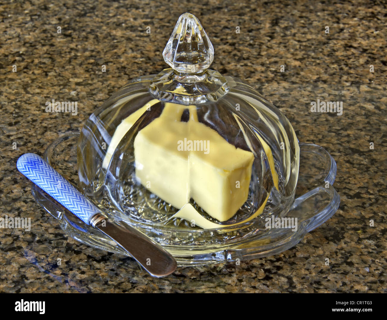 home related image is a cube of soft butter in a crystal butter dish ...