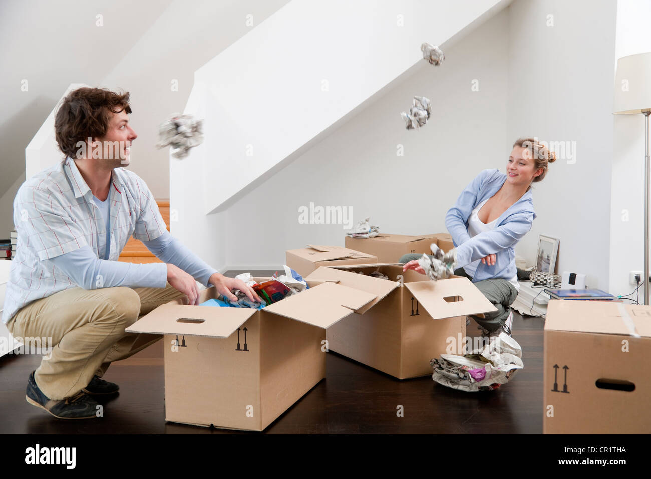 Couple unpacking cardboard boxes Stock Photo - Alamy
