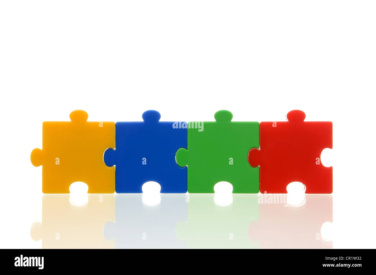 Four different coloured puzzle pieces, connected, symbolic image, team ...