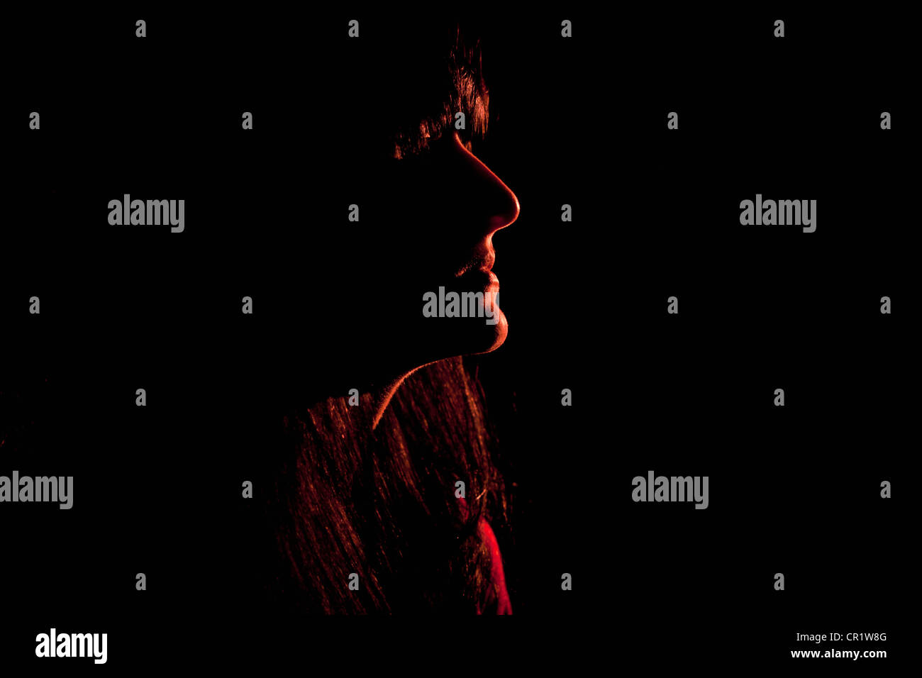 Illuminated profile of womans face Stock Photo - Alamy