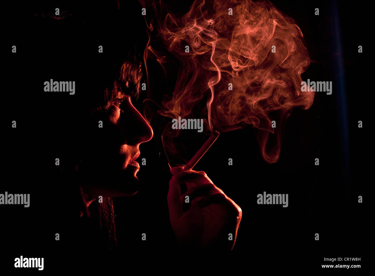 Illuminated profile of woman smoking Stock Photo - Alamy