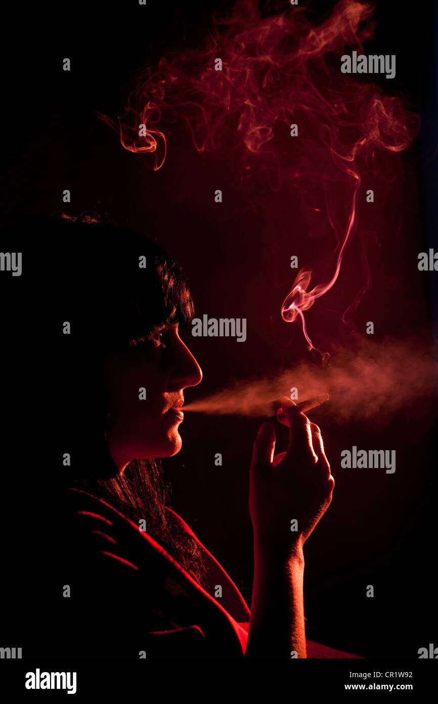 Woman smoking cigarette hi-res stock photography and images - Alamy