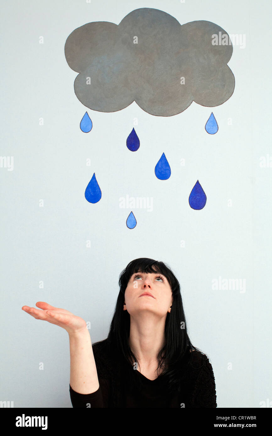Woman standing under painted rain cloud Stock Photo - Alamy