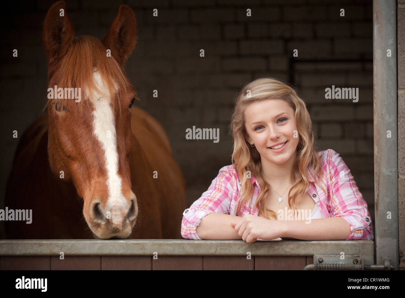 Teenage girl with horse in stables Stock Photo - Alamy