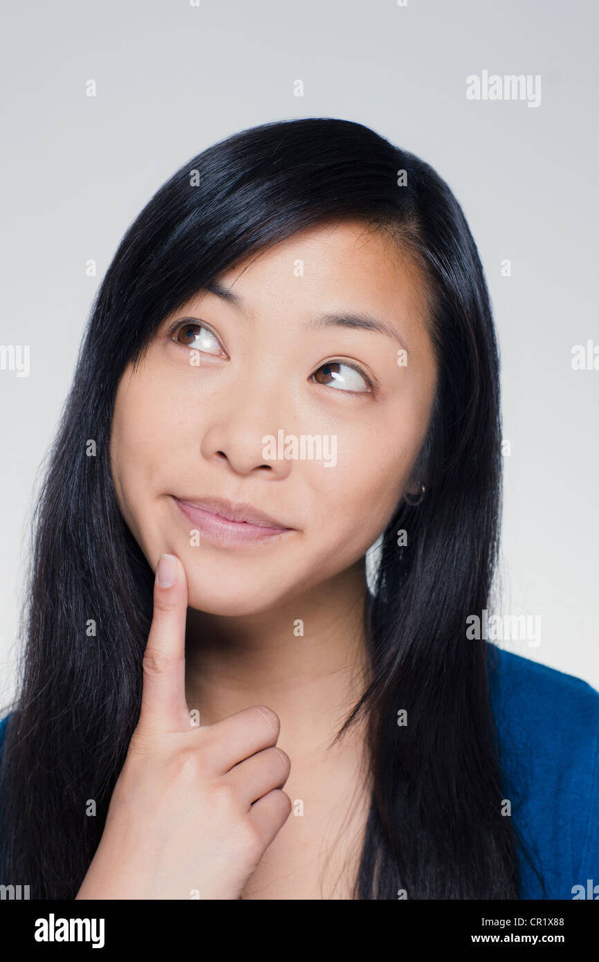Studio portrait of young woman looking up Stock Photo - Alamy