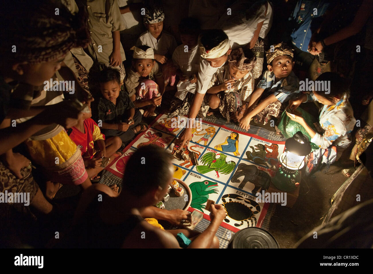 Children gambling at a Candiddasa temple festival Stock Photo - Alamy
