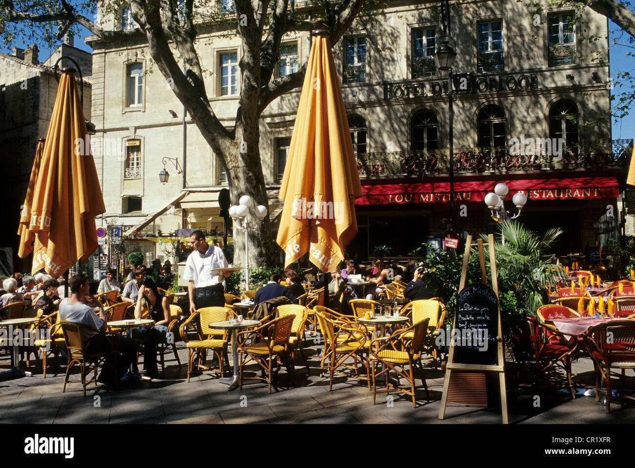 France, Vaucluse, Avignon, terrace of restaurant on place de l'horloge ...