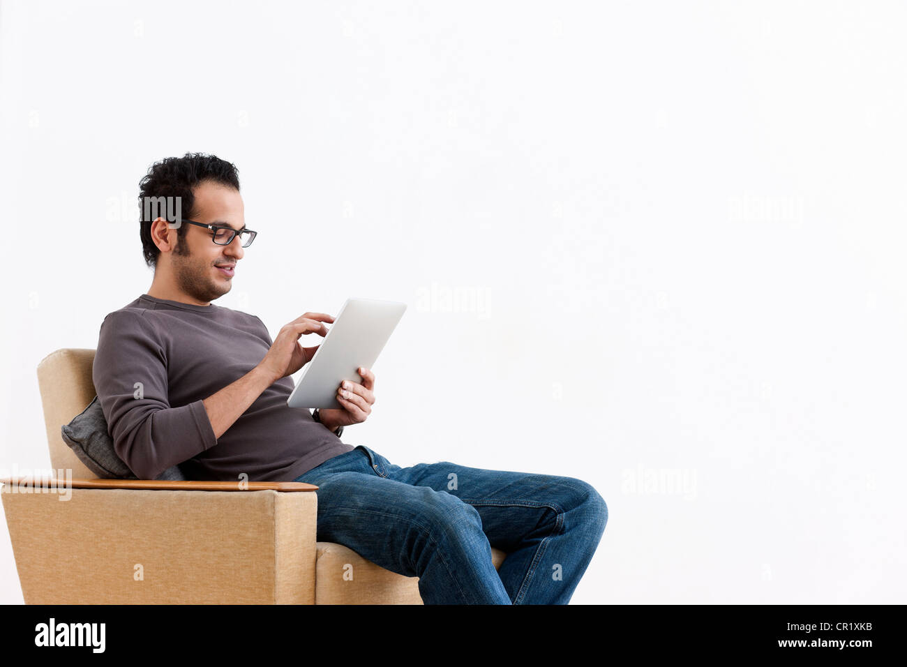 Smiling man using tablet computer Stock Photo - Alamy