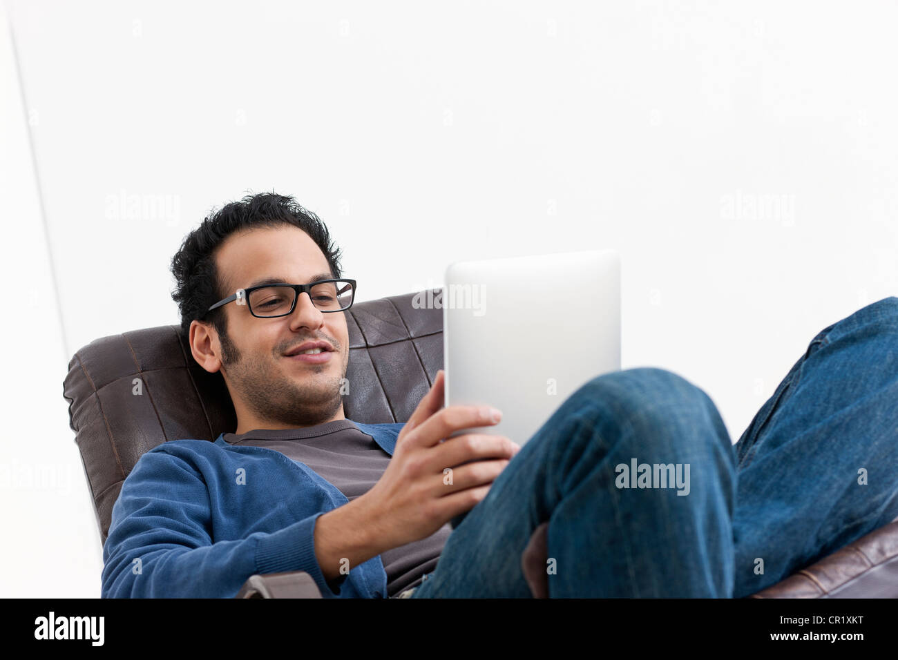 Smiling man using tablet computer Stock Photo - Alamy