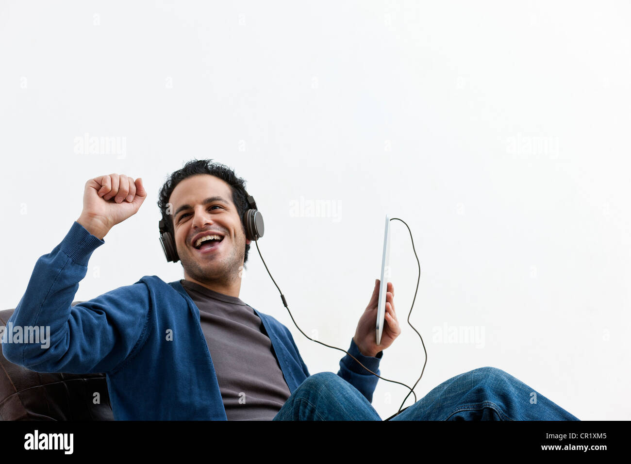 Man in headphones dancing in chair Stock Photo - Alamy