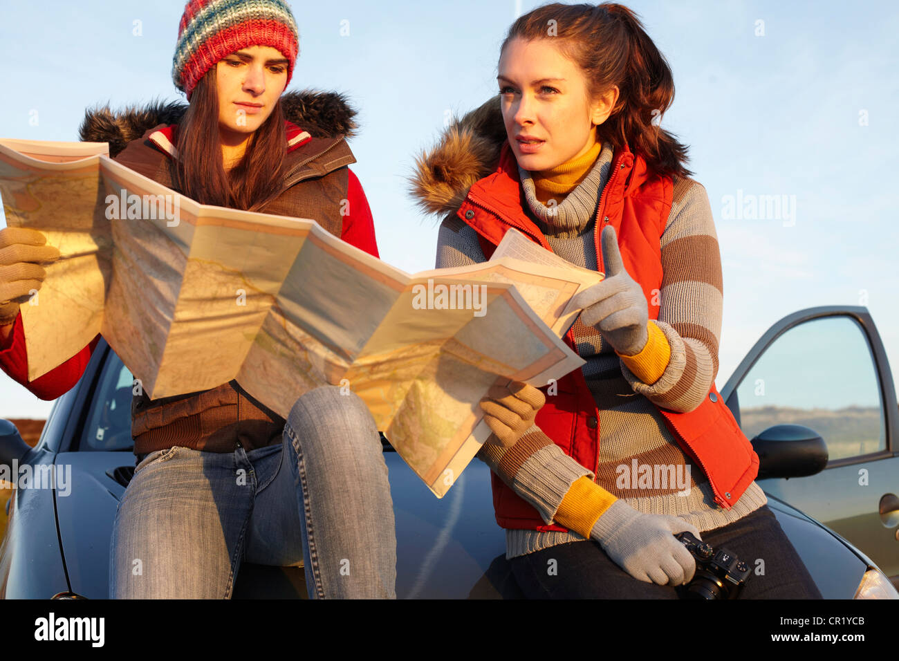Women reading map by car Stock Photo - Alamy
