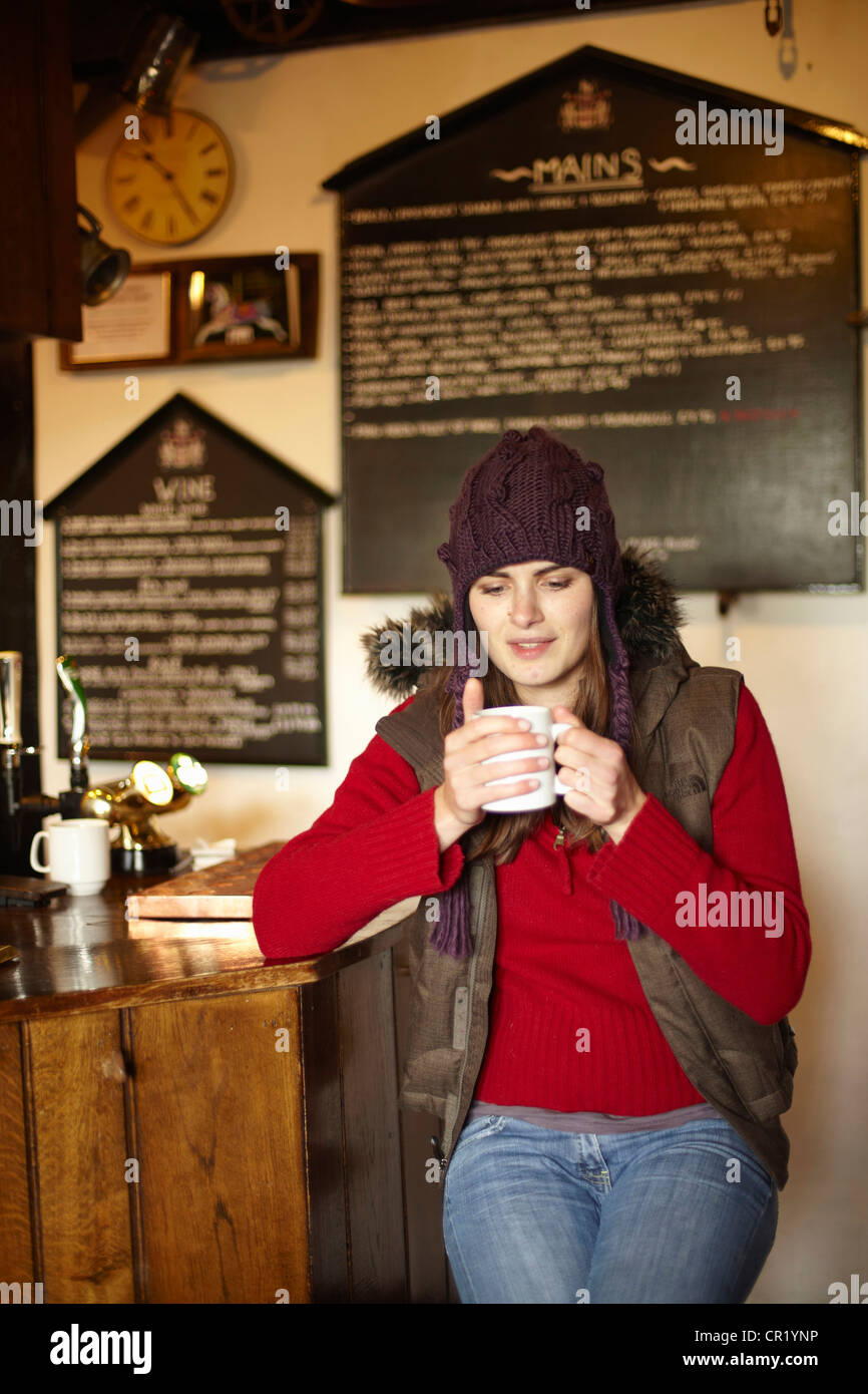 Woman drinking coffee in cafe Stock Photo - Alamy