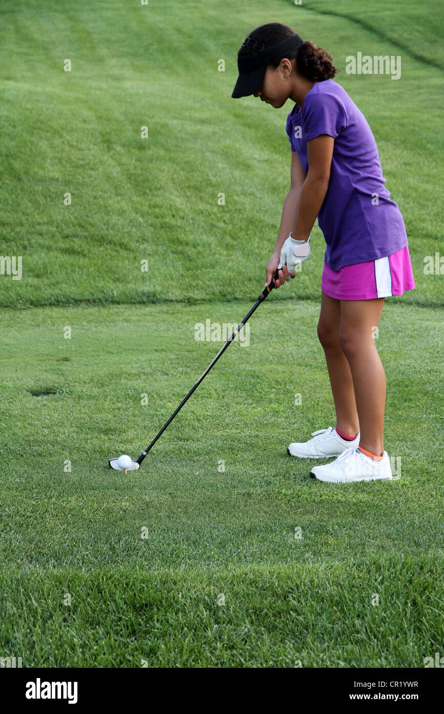 Girl hitting a driver on the golf course Stock Photo - Alamy