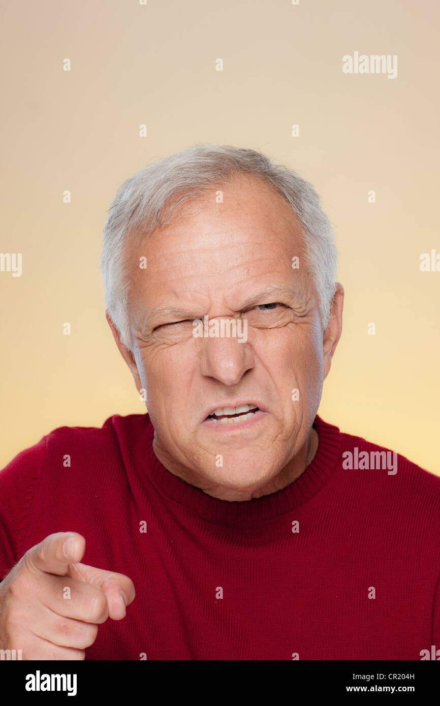 Studio shot of angry senior man Stock Photo - Alamy
