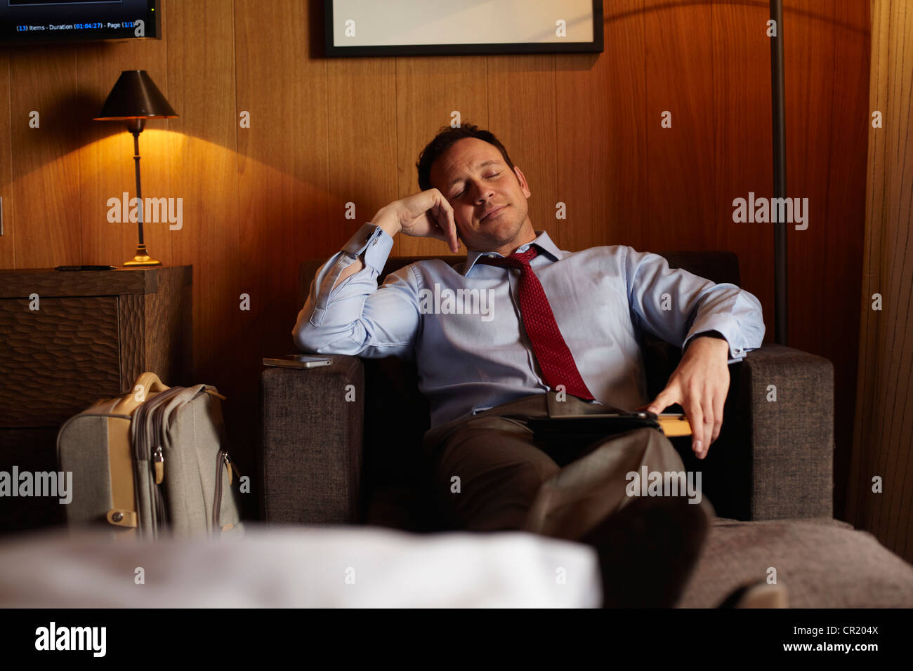 Businessman napping in hotel room Stock Photo - Alamy
