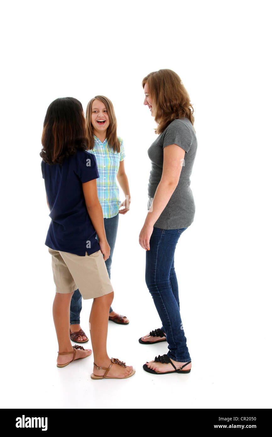 Teenage children standing talking against a white background Stock ...