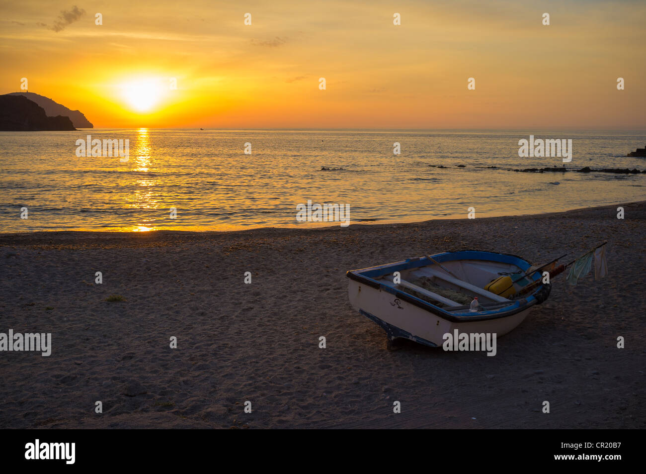 Sunrise on a traditional fishing boat ashore Isleta del Moro beach ...