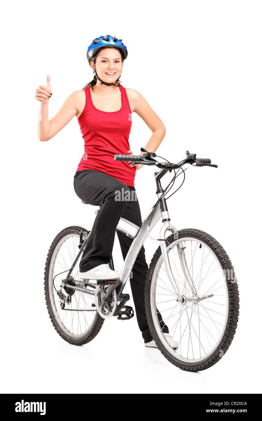 Full length portrait of a female bicyclist posing on a bicycle and ...