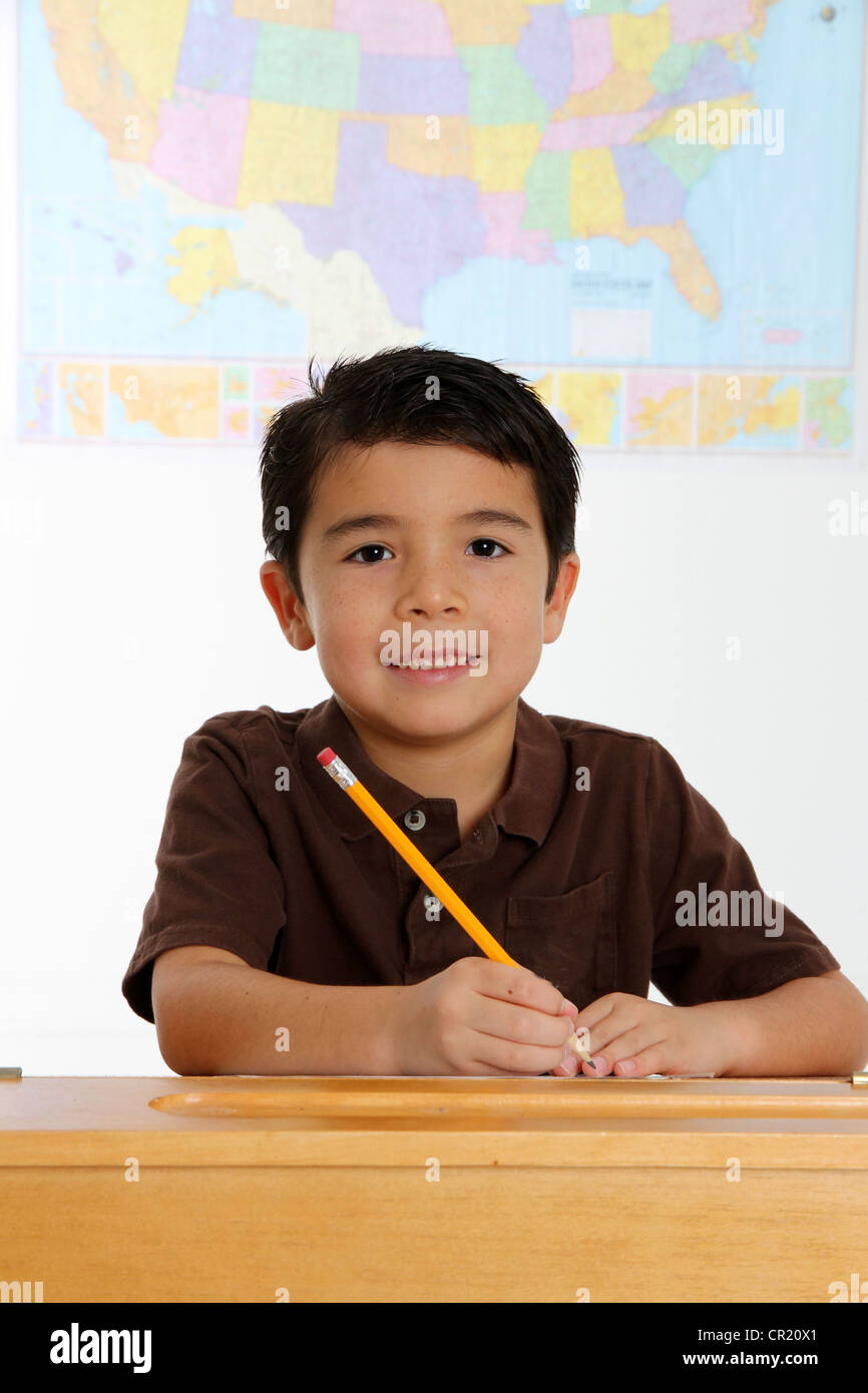 Young Boy Working at Desk in School Stock Photo - Alamy