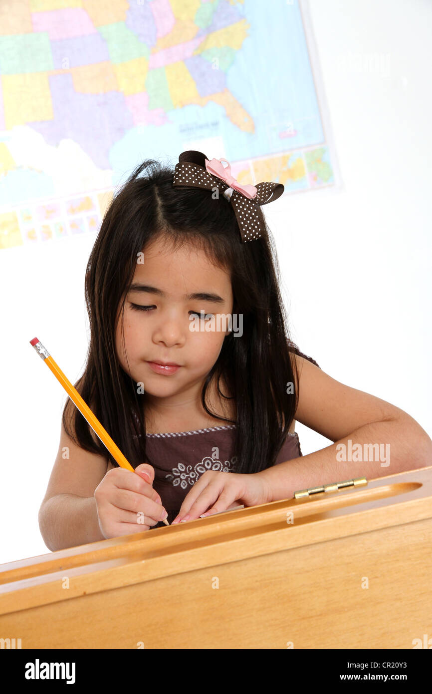 Elementary aged girl in her school classroom Stock Photo - Alamy