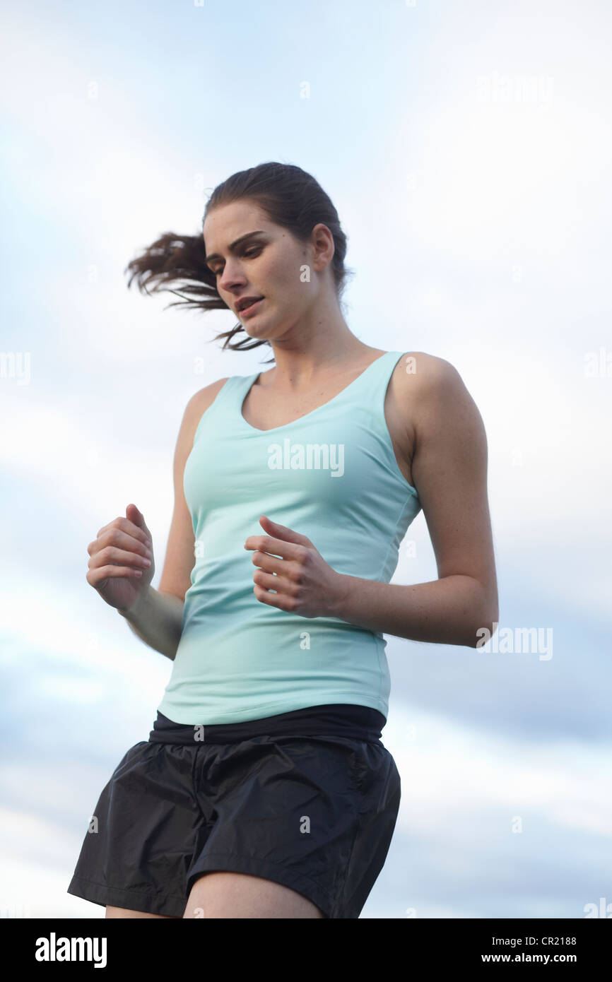 Woman running outdoors Stock Photo - Alamy
