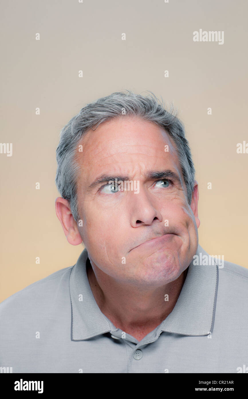 Studio Portrait of mature man making a face Stock Photo - Alamy