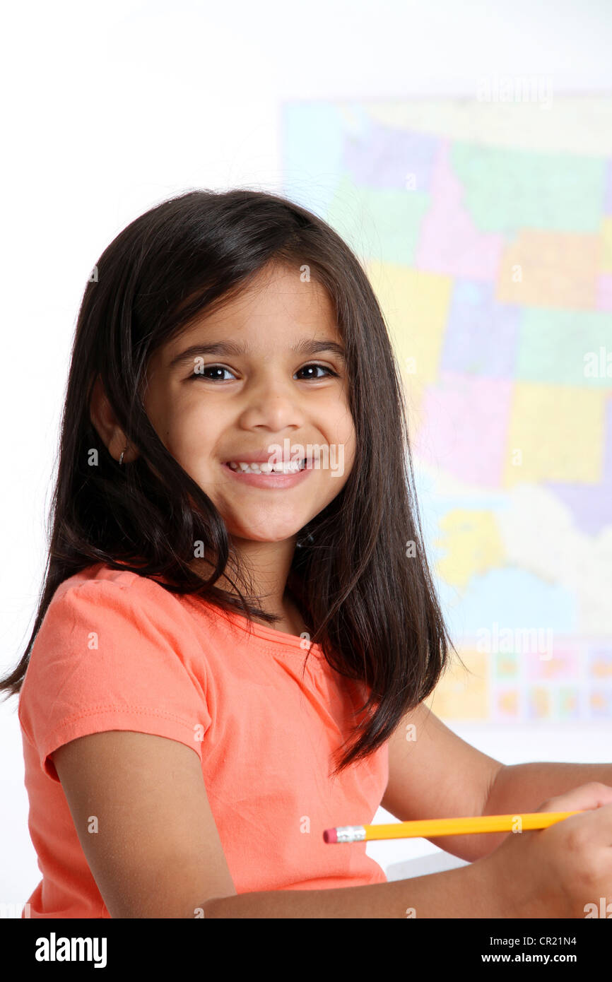Elementary aged girl in her school classroom Stock Photo - Alamy