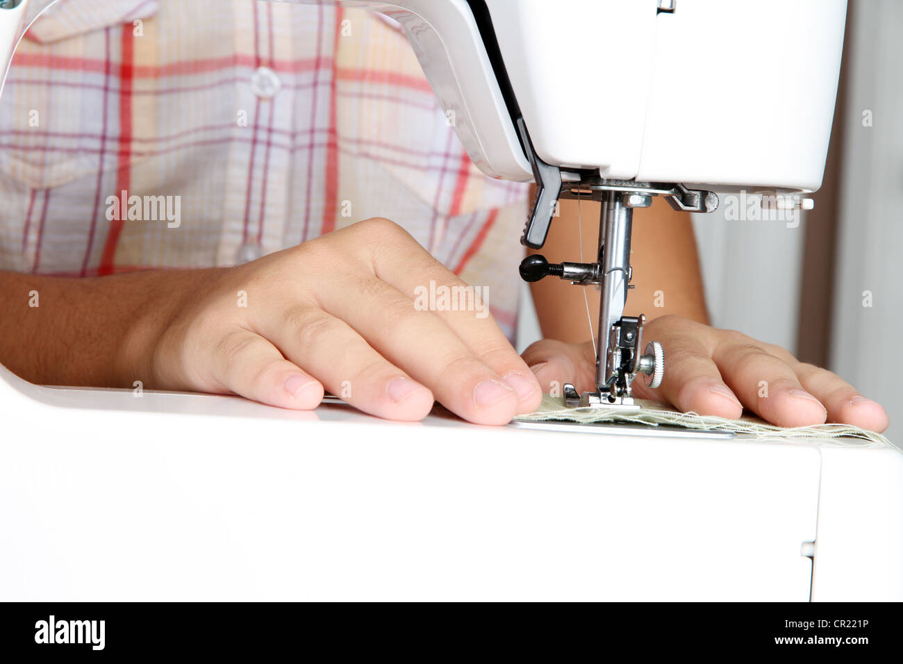 Girl using a sewing machine to make crafts Stock Photo - Alamy