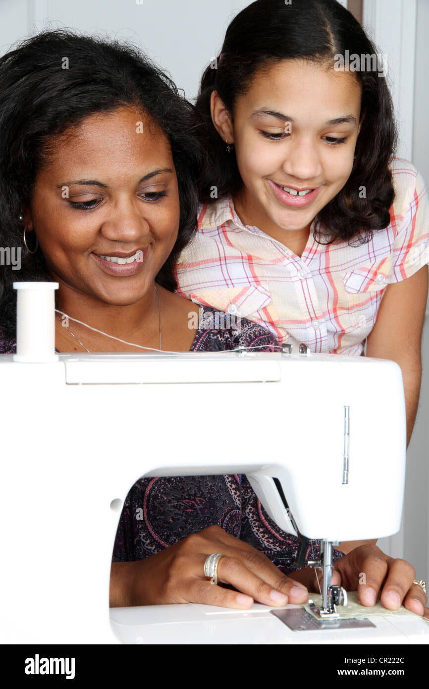 Girl and mother using a sewing machine to make crafts Stock Photo - Alamy