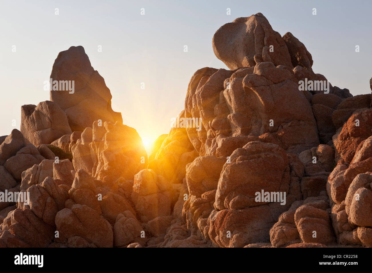 Sun shining through rock formations Stock Photo - Alamy