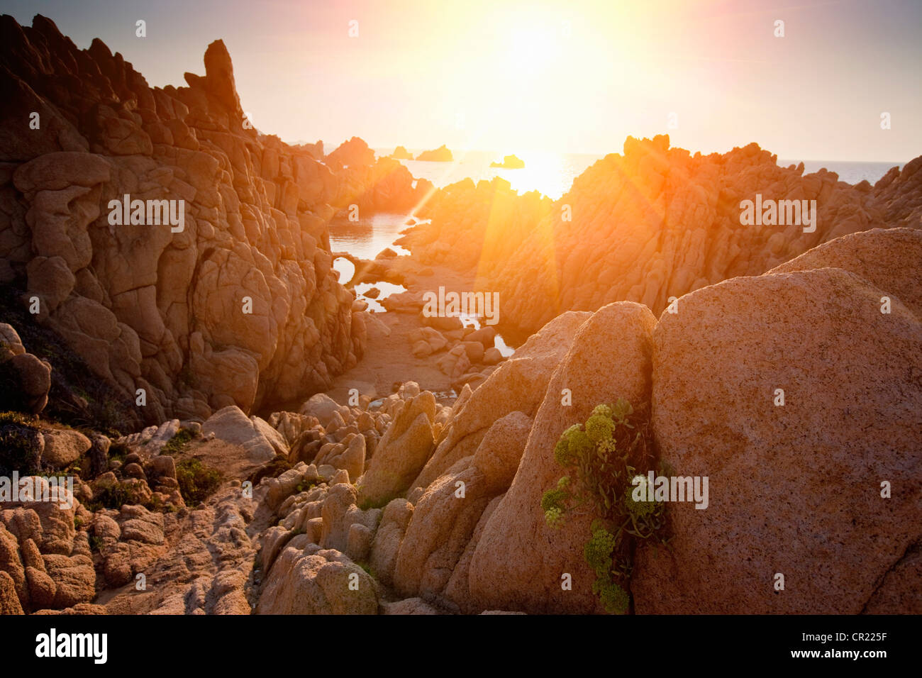Sun shining through rock formations Stock Photo - Alamy