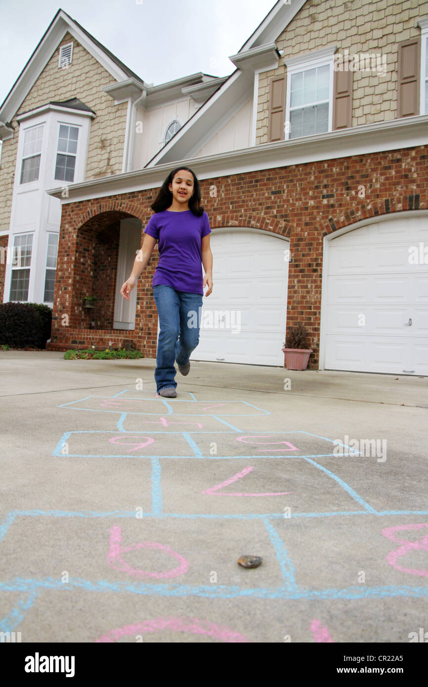 Child playing hopscotch outside at her home Stock Photo - Alamy