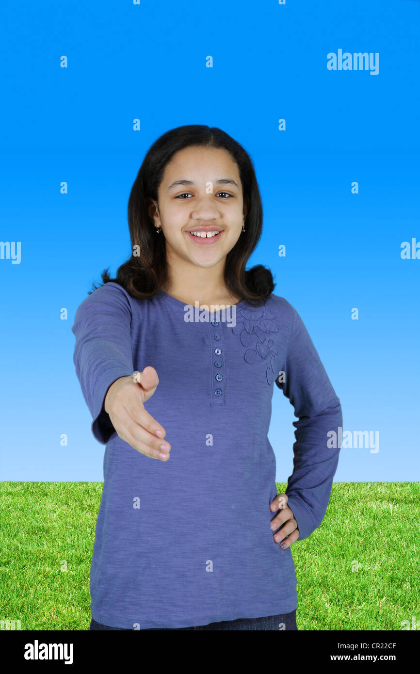 Girl outside in the grass shaking hands Stock Photo - Alamy