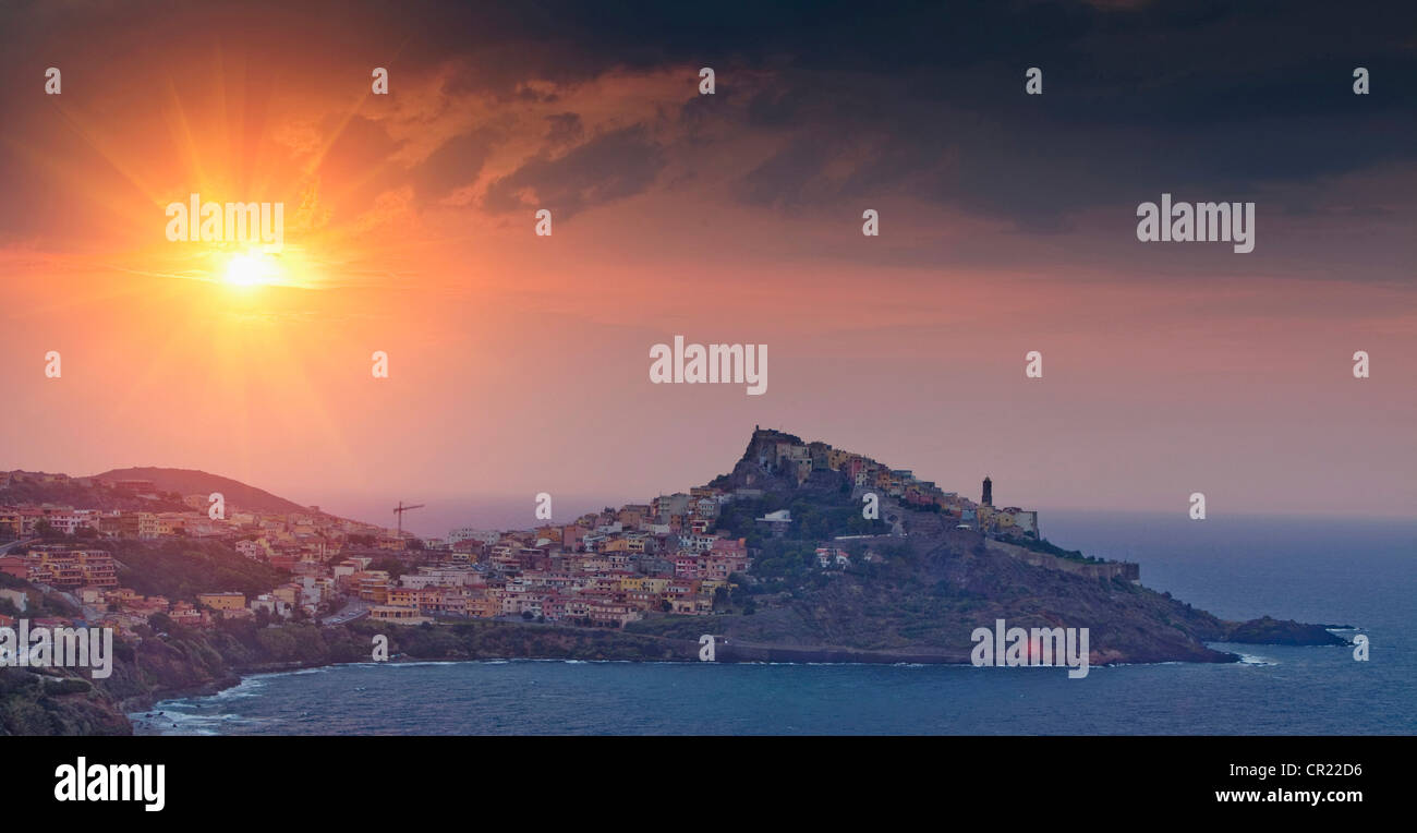 Sun setting over village on hillside Stock Photo - Alamy