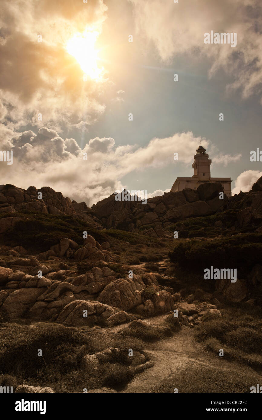 Lighthouse on rocky coastline Stock Photo - Alamy